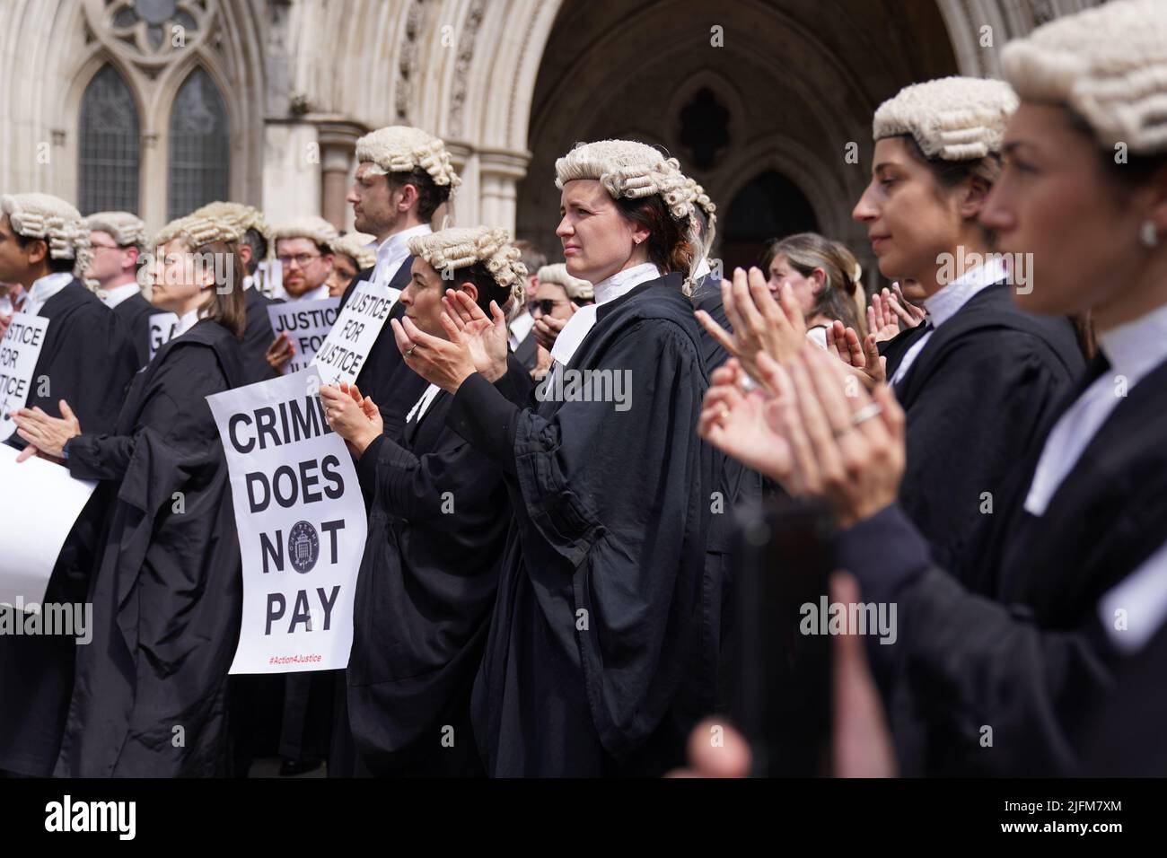 Criminal defence barristers gather outside the Royal Courts of Justice ...