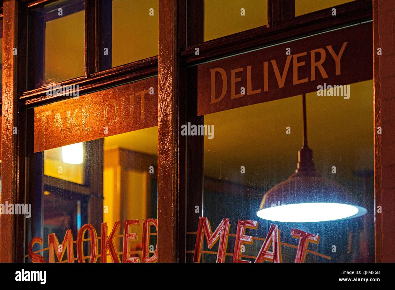 Take out and delivery plus smoked meat sign in the widow of a 1950s ...