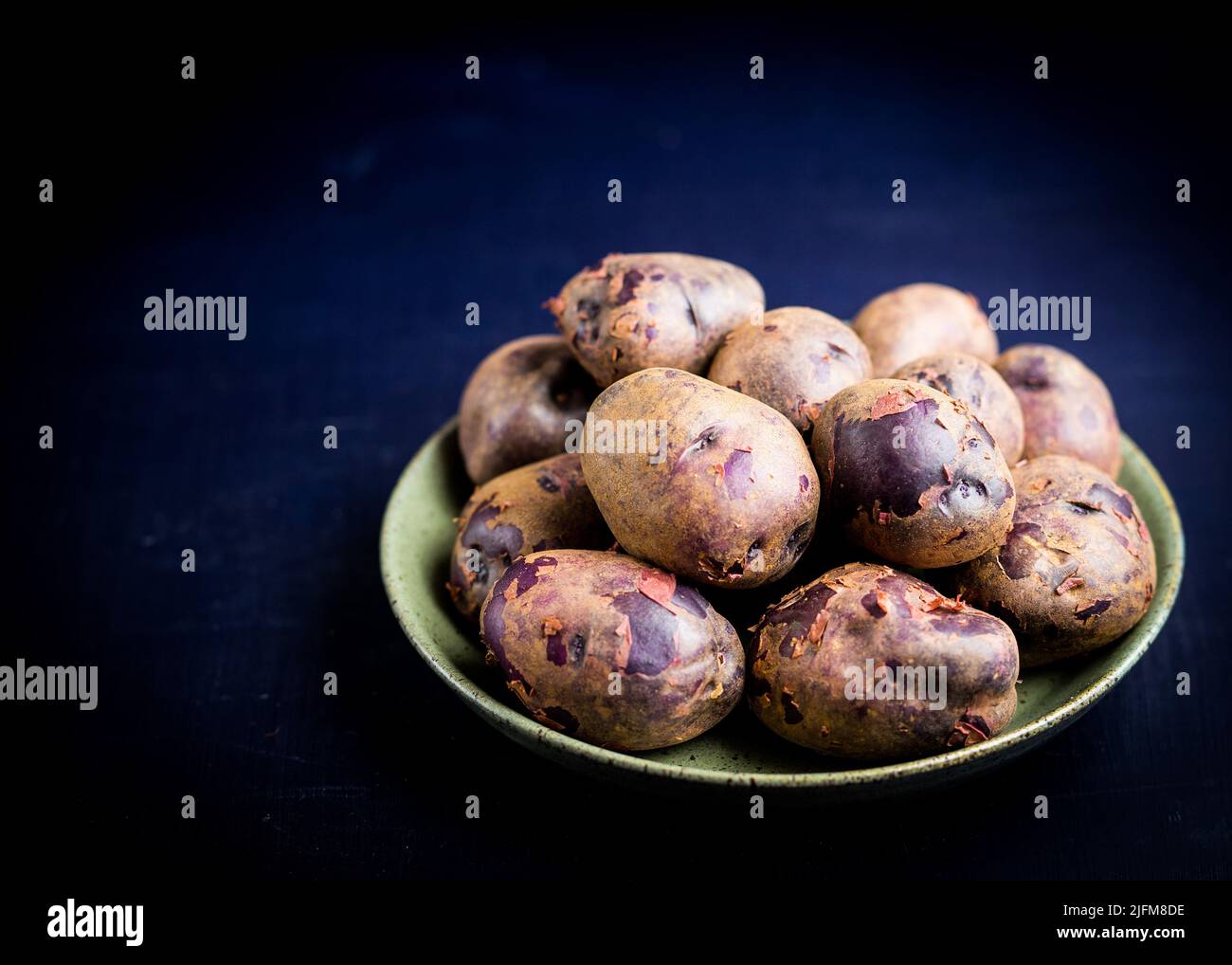 Blue potatoes in a bowl Stock Photo - Alamy