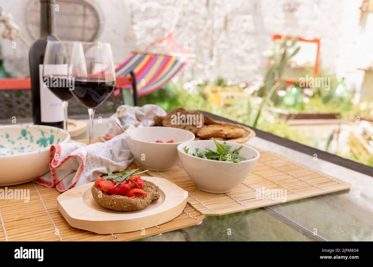 Italian summer appetizer Friselle with cherry tomatoes, oil and rucola ...