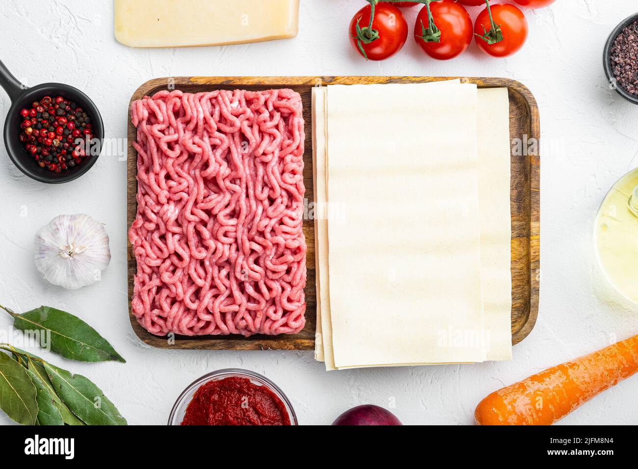 Different ingredients for lasagna, on white stone background, top view ...