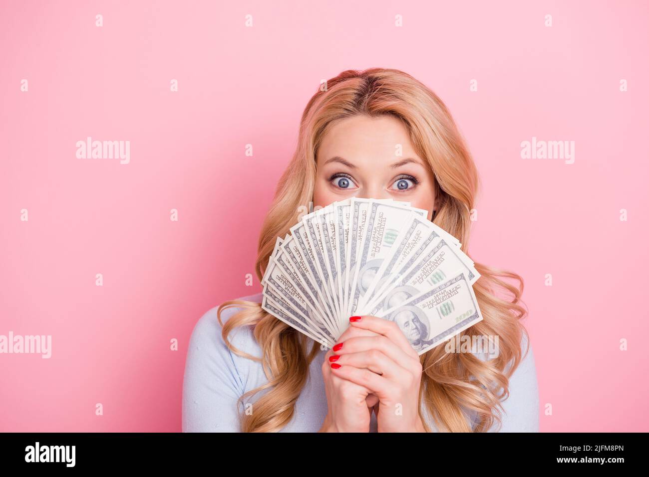 Photo of young lady hold dollars banknotes covering face look camera ...