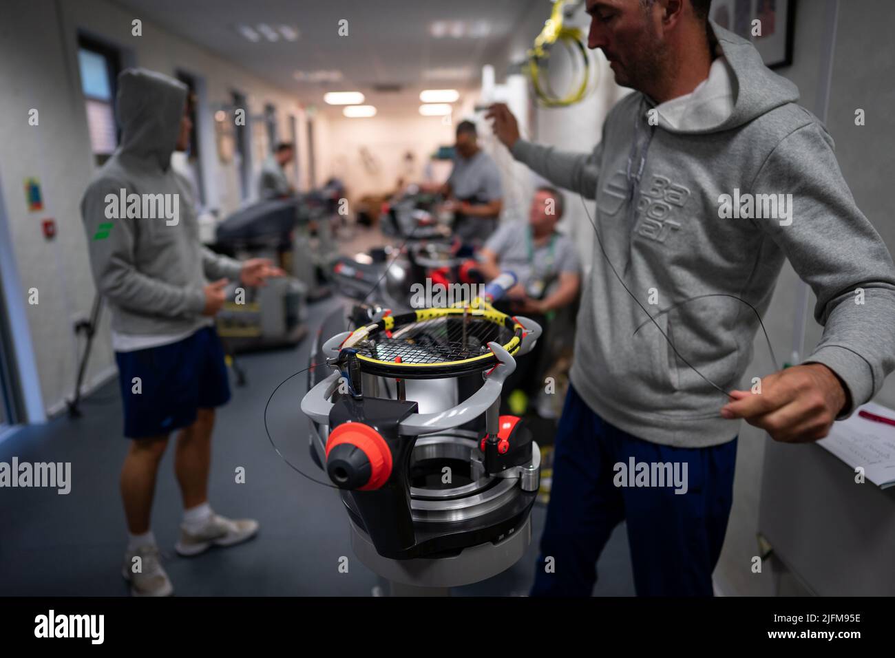 A racket being strung in the Stringing Room on day eight of the 2022 ...