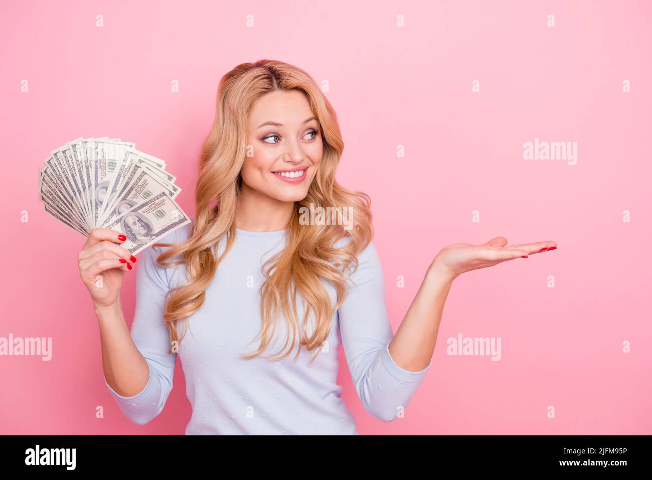 Portrait of pretty positive lady arm palm hold cash demonstrate empty ...