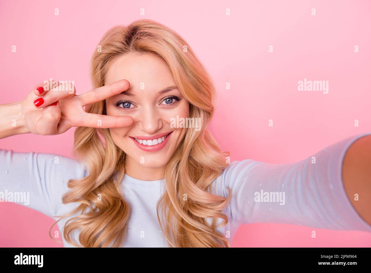Photo of funky pretty girl make selfie hand fingers demonstrate v-sign ...