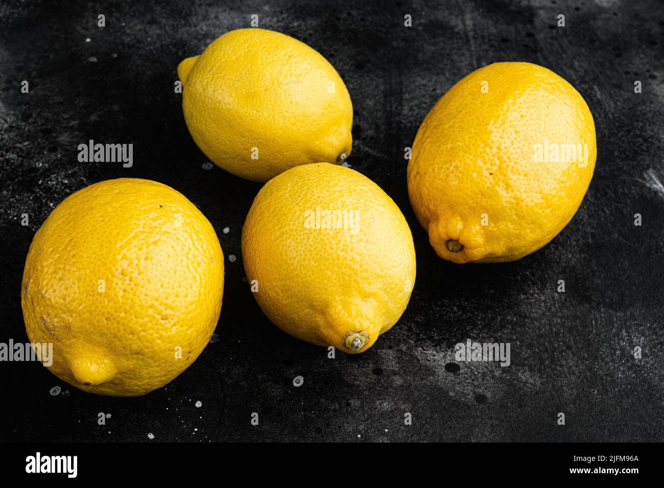 Fresh ripe lemons, on black dark stone table background Stock Photo - Alamy