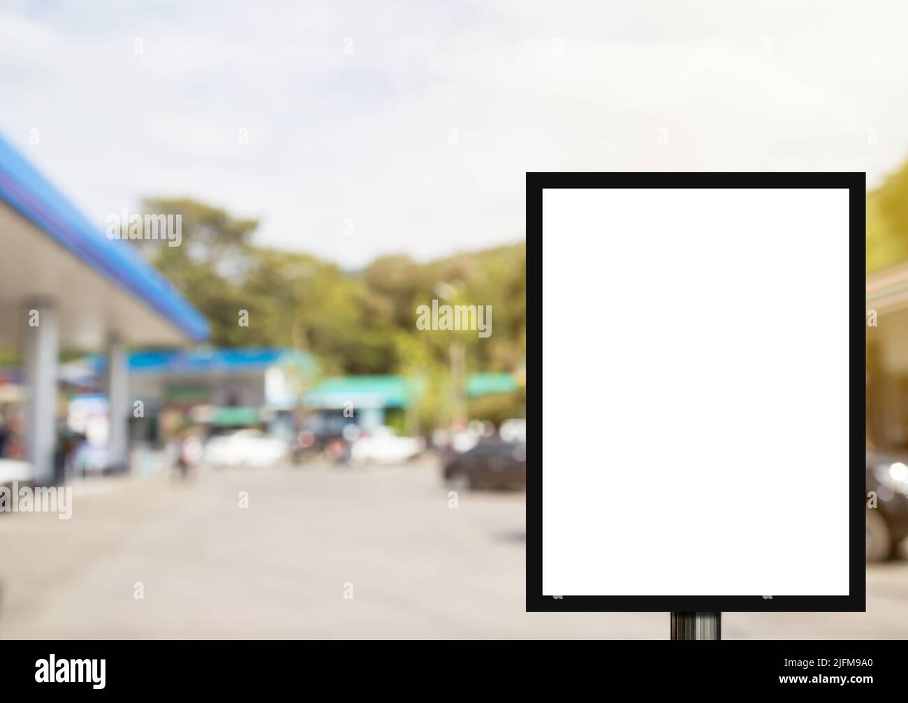 Blank advertising billboard or wide screen television with blurred gas ...