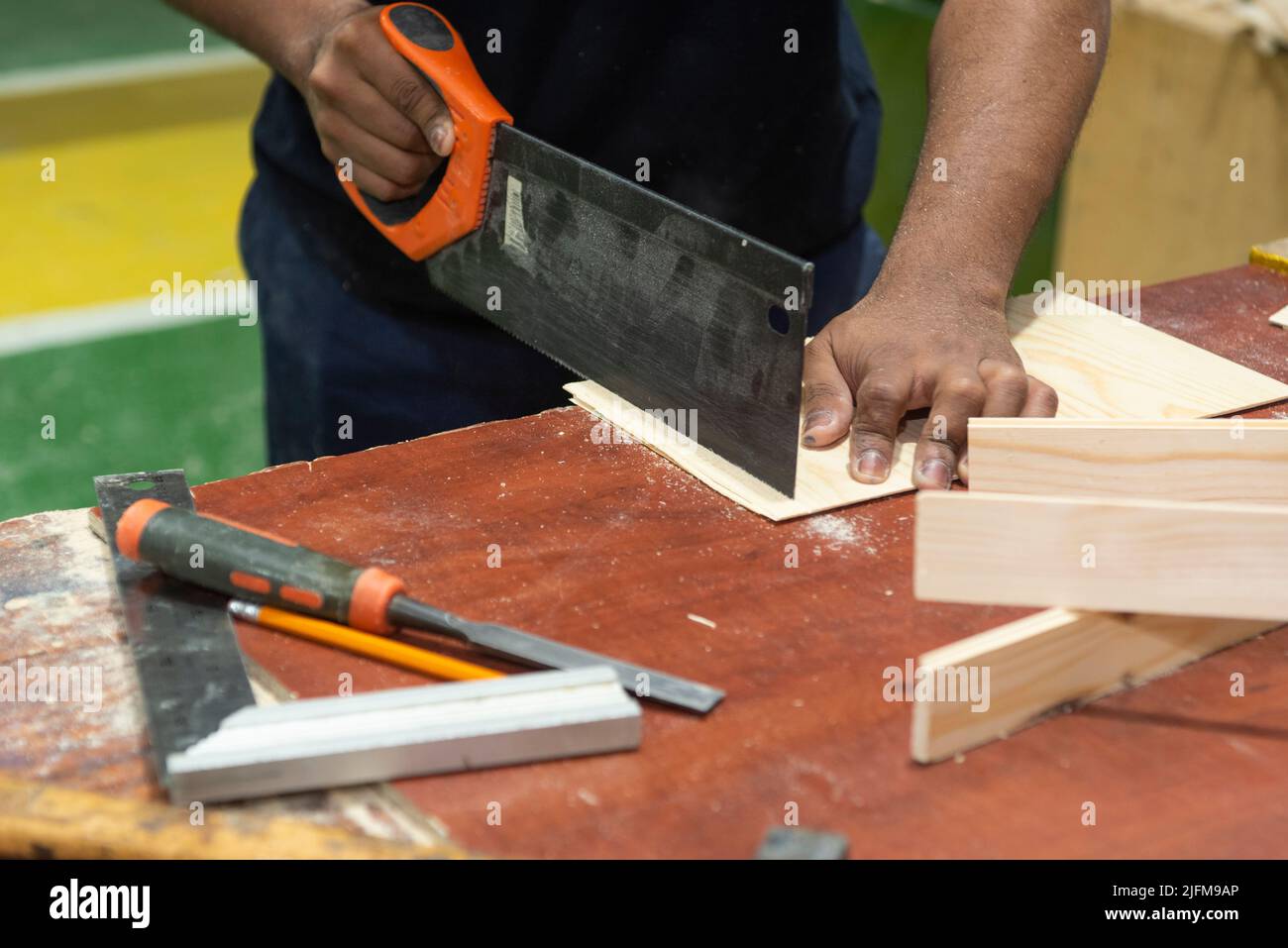Hands of a carpenter man cutting wood with a precision handsaw Stock ...