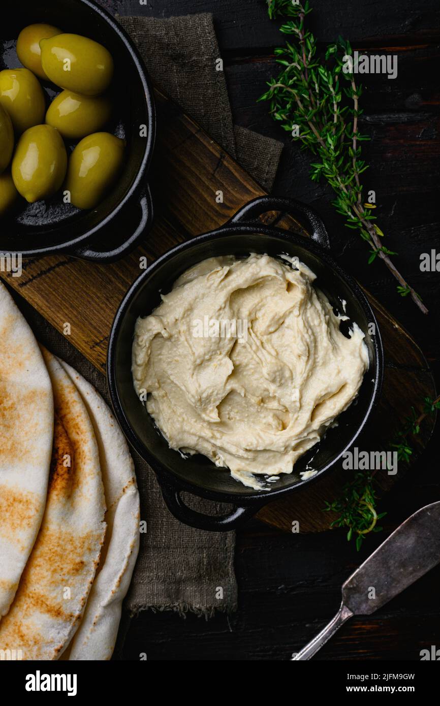 Healthy Homemade Creamy Hummus set, on old dark wooden table background ...