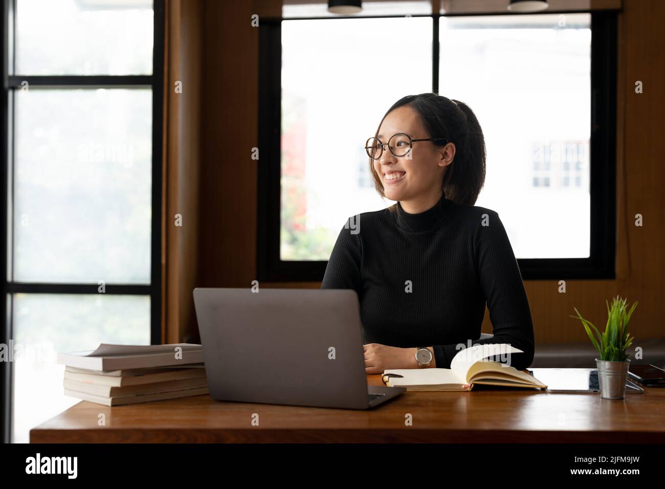 Female student study in the school library.She using laptop and ...
