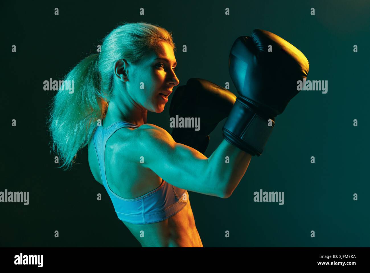 Closeup one young woman, female professional kickboxer in sports ...