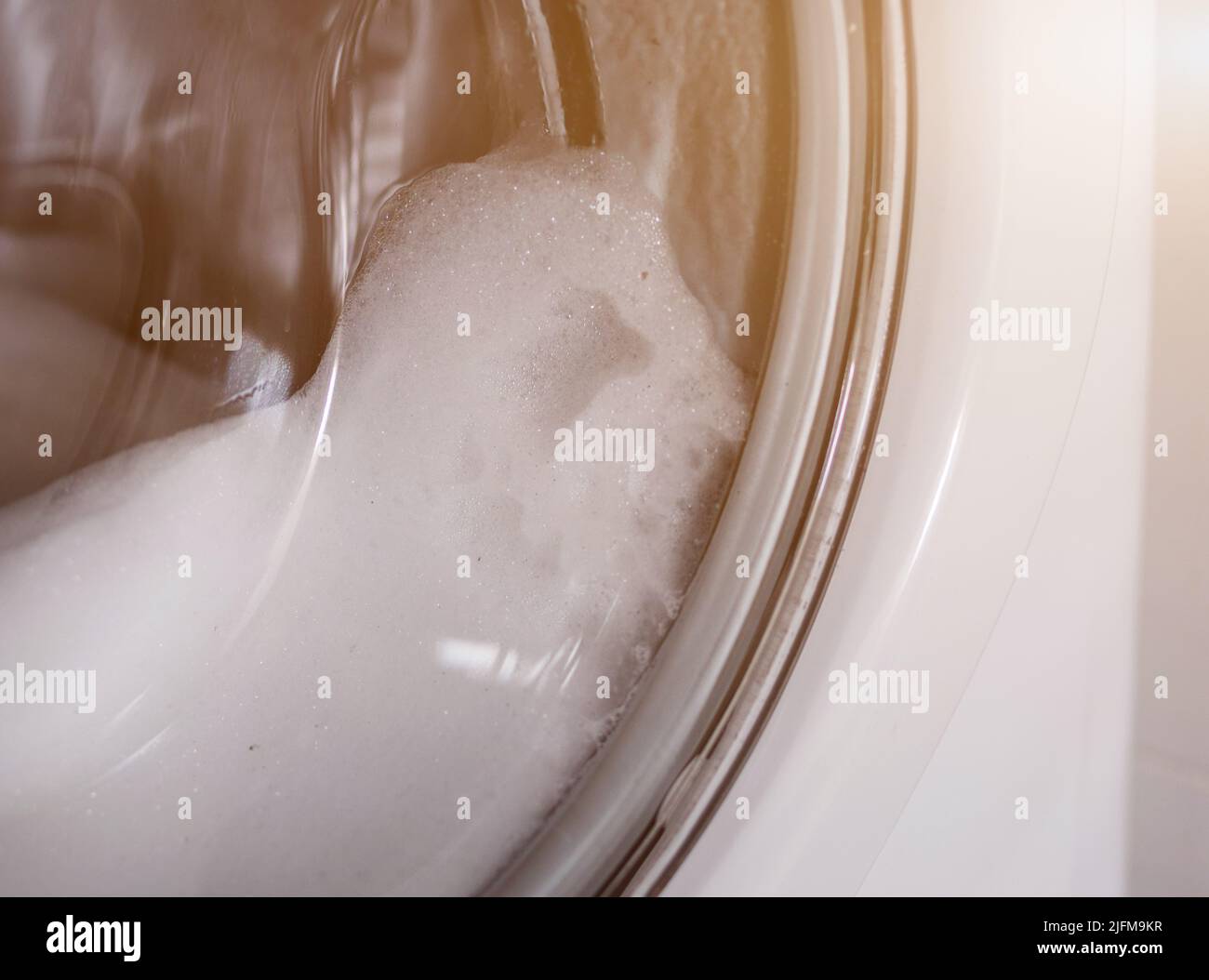 White automatic washing machine make foam Stock Photo - Alamy