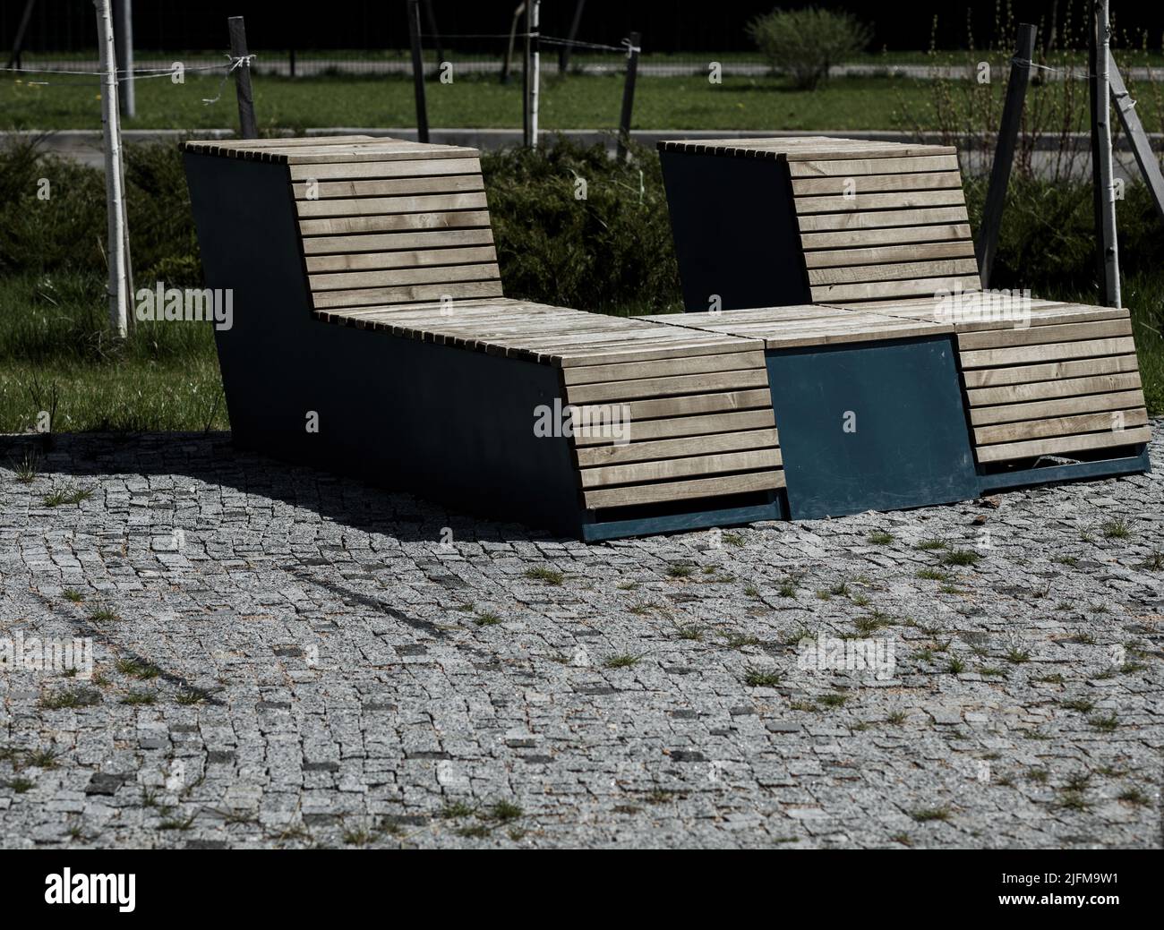 modern bench with greenery in a city park . place to relax. urban space ...