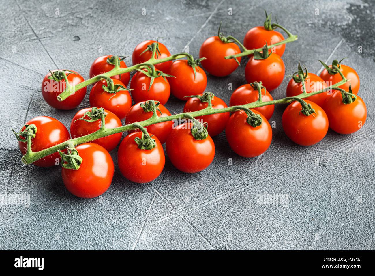 Cluster of fresh red cherry tomatoes, on gray stone background Stock ...