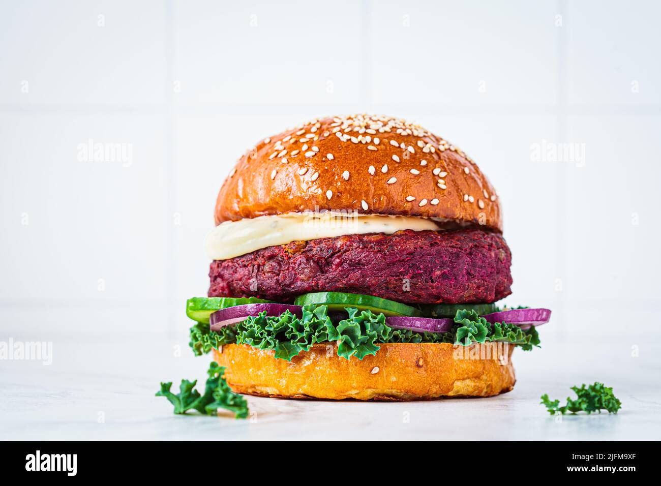 Beetroot vegan burger with kale, onion and cucumber, light background ...