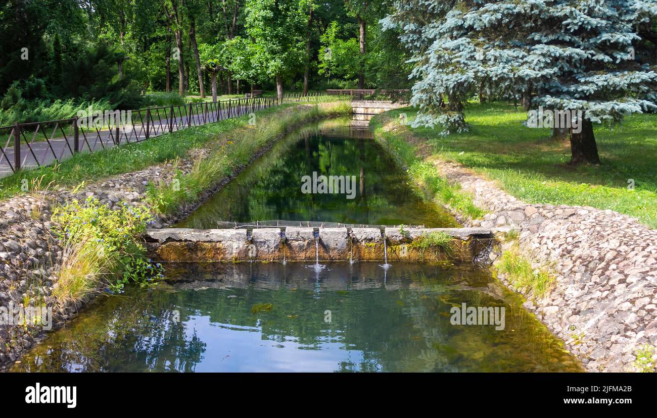 Europe. Botanical Garden. Area of a small river with a small bridge ...