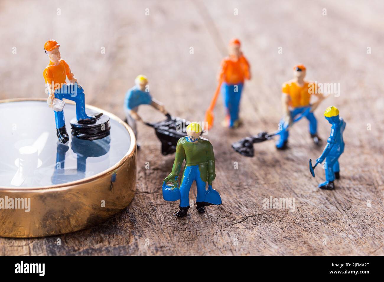 Miniature people- Figures construction worker, is working on a cracked ...