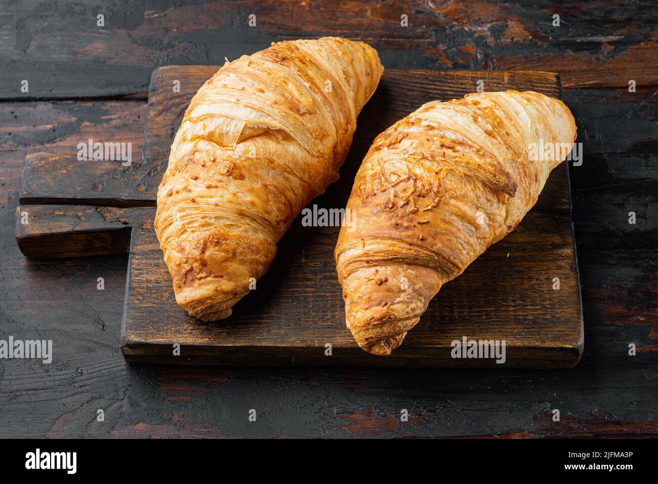 Freshly baked croissants, on old dark wooden table background Stock ...