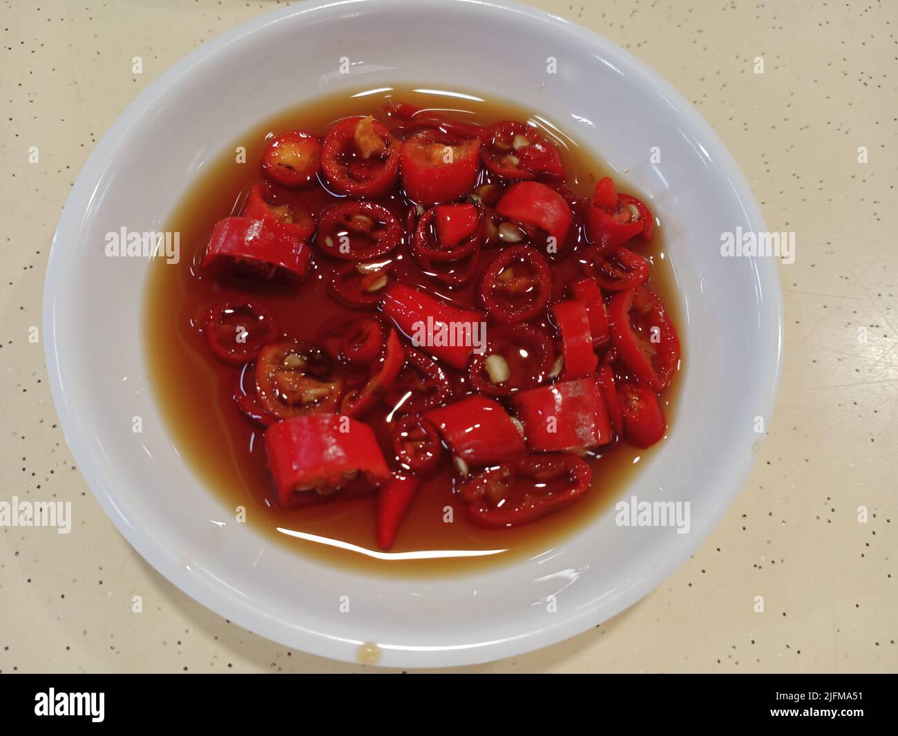 red colour chili sauce in small plate Stock Photo - Alamy