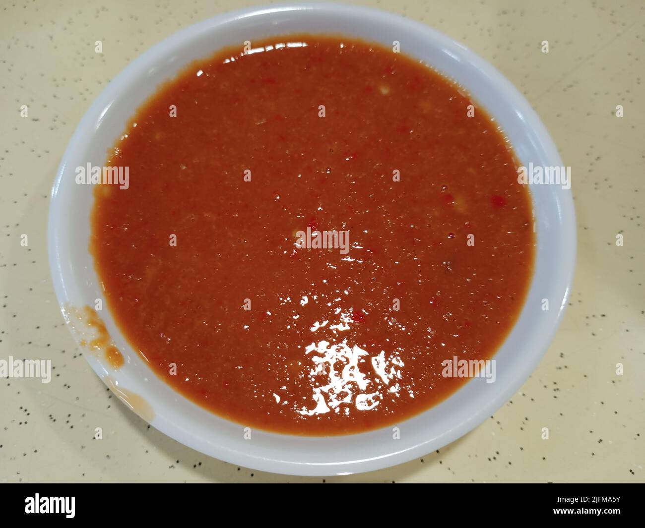 red colour chili sauce in small plate Stock Photo - Alamy