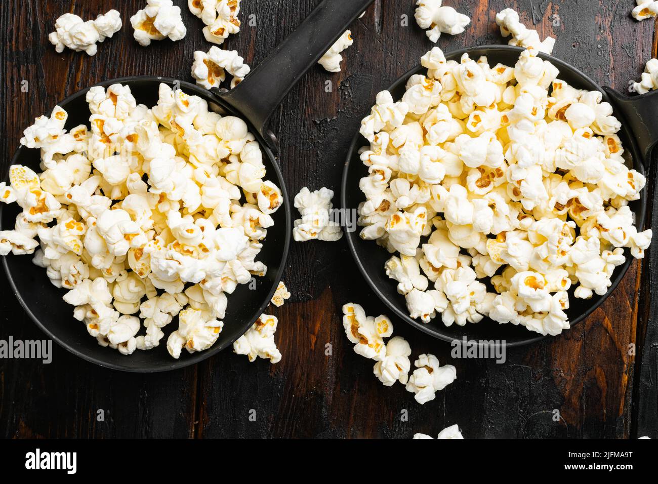 Heap of salted popcorn on old dark wooden table background, top view ...
