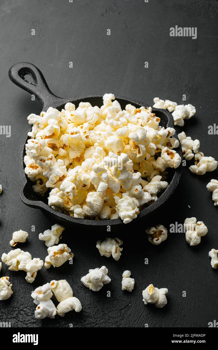 Salted popcorn on black dark stone table background Stock Photo - Alamy