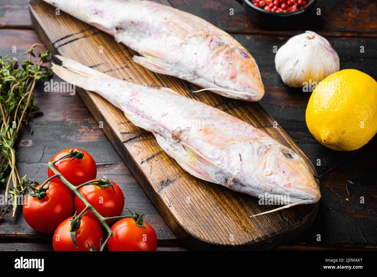 Raw fresh mullet or barabulka whole fish, with ingredients and herbs ...