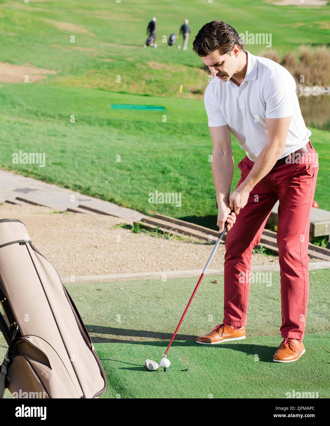 Action man hitting golf ball hi-res stock photography and images - Alamy