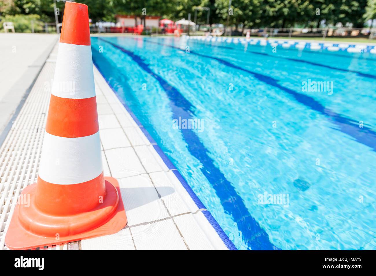 swimming pool repair - safety cone on edge Stock Photo - Alamy