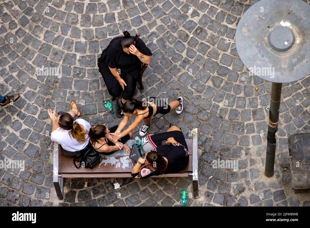 Italian family sitting and playing in Naples square Stock Photo - Alamy