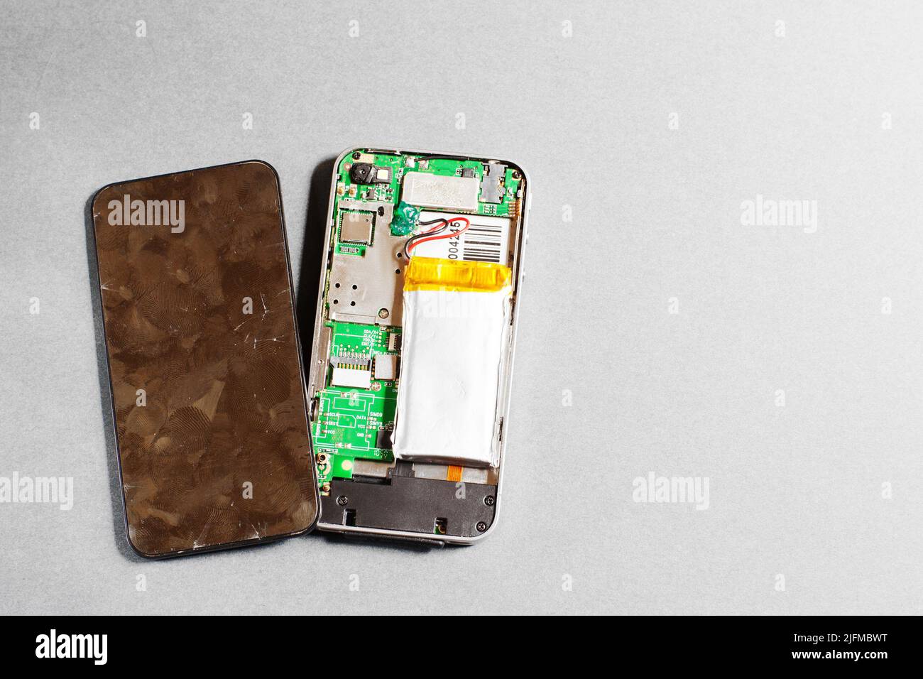 Old disassembled smartphone on gray background Stock Photo - Alamy