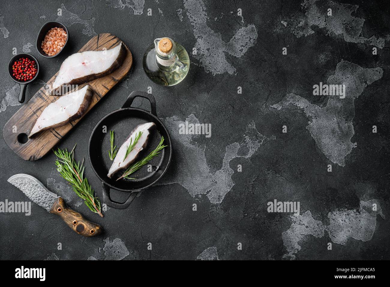 Piece of fresh raw halibut fish, with ingredients and rosemary herbs ...