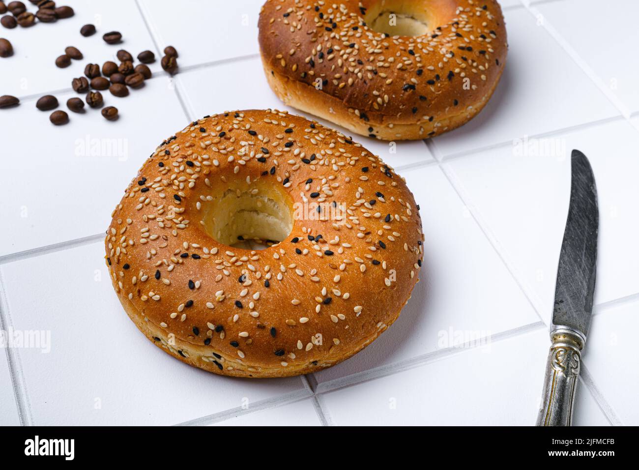 Bagel Freshly Baked set, on white ceramic squared tile table background ...