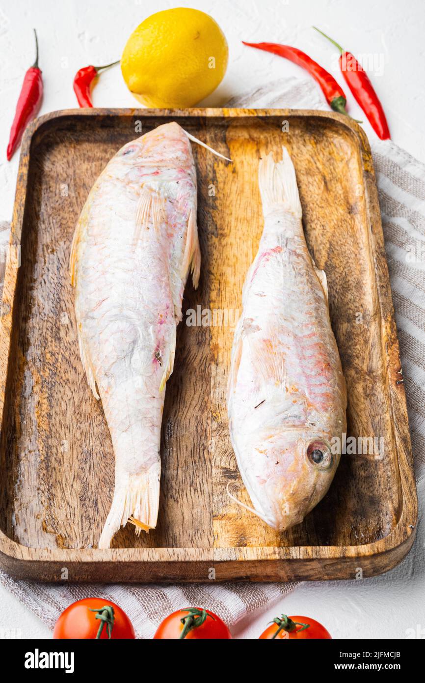 Raw fresh mullet or barabulka whole fish, with ingredients and herbs ...