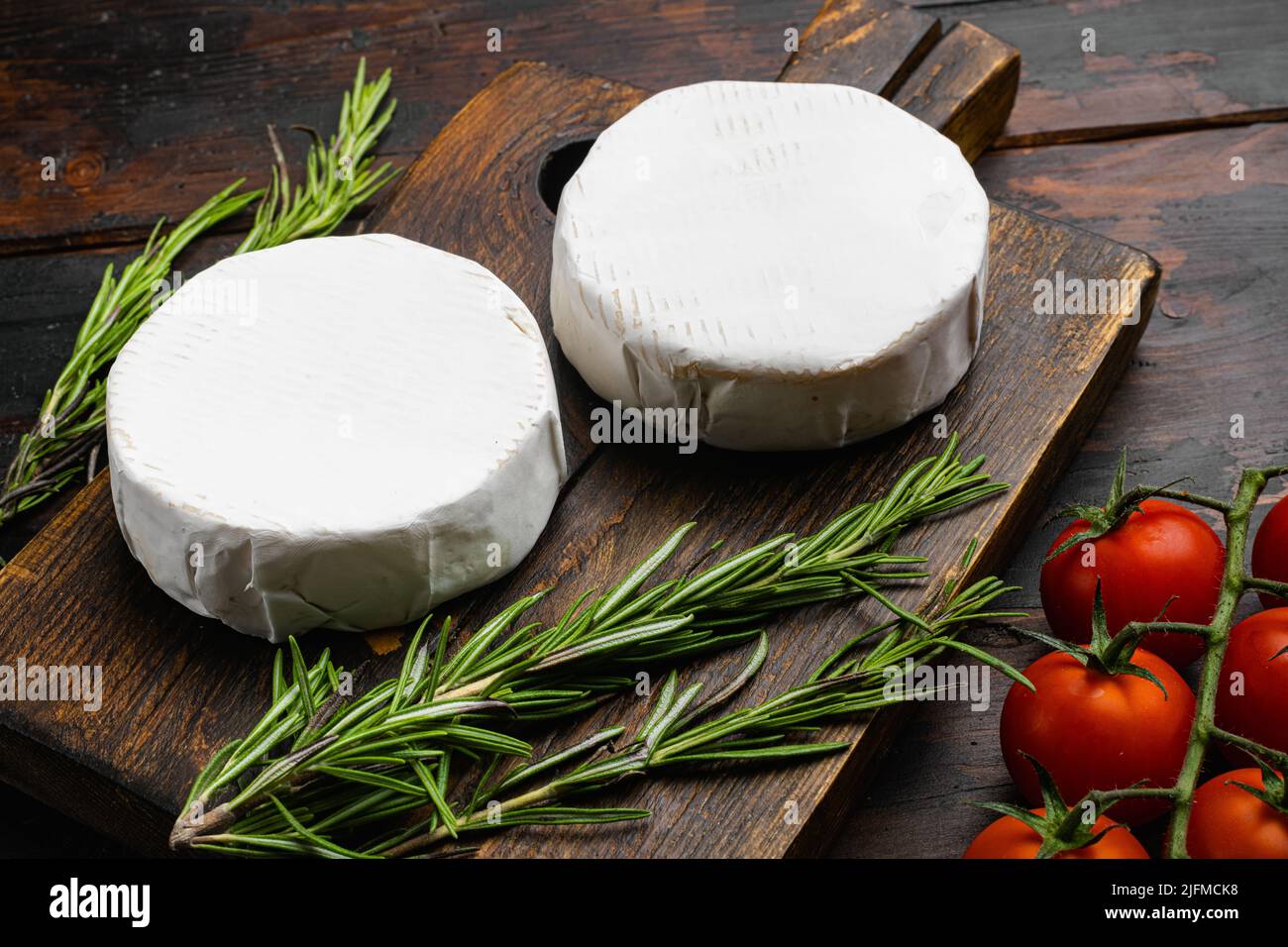 Creamy Brie cheese on old dark wooden table background Stock Photo - Alamy