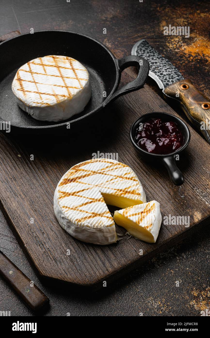 Oven Backed camembert on old dark rustic table background Stock Photo ...