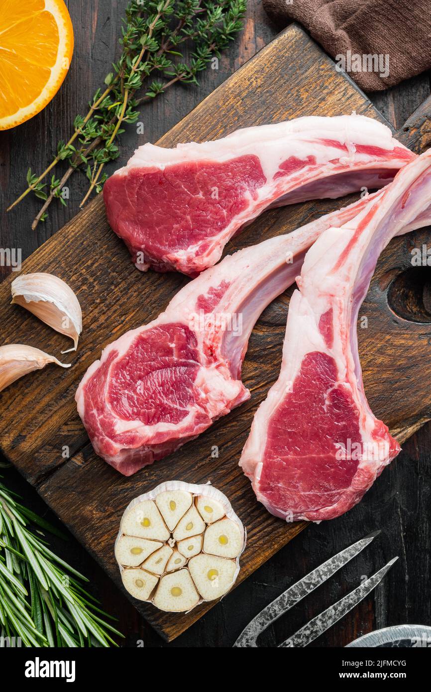 Raw Lamb Filets on bone, with ingredients carrot orange, herbs, on old ...
