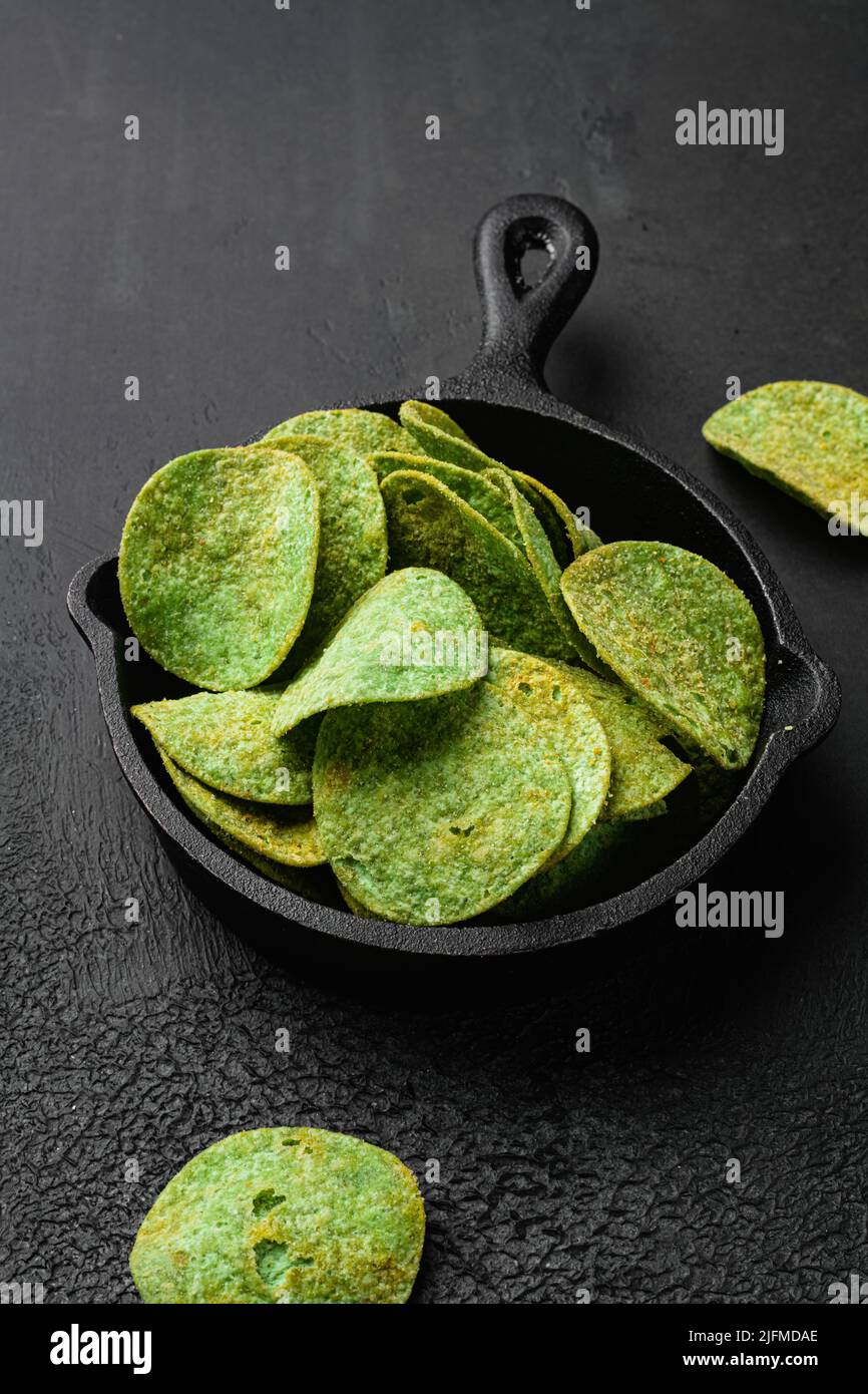 Green Chile Limon Flavored Potato Chips on black dark stone table ...