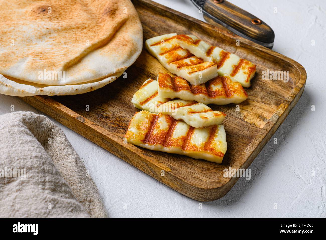 Traditinal Cypriot Halloumi Cheese, on white stone table background ...