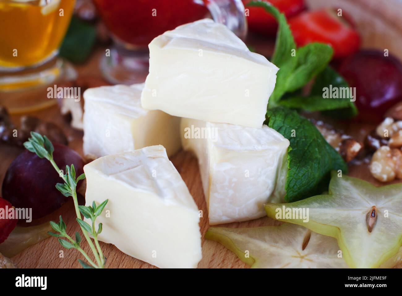 Processed cheese triangles with fruits close-up Stock Photo - Alamy