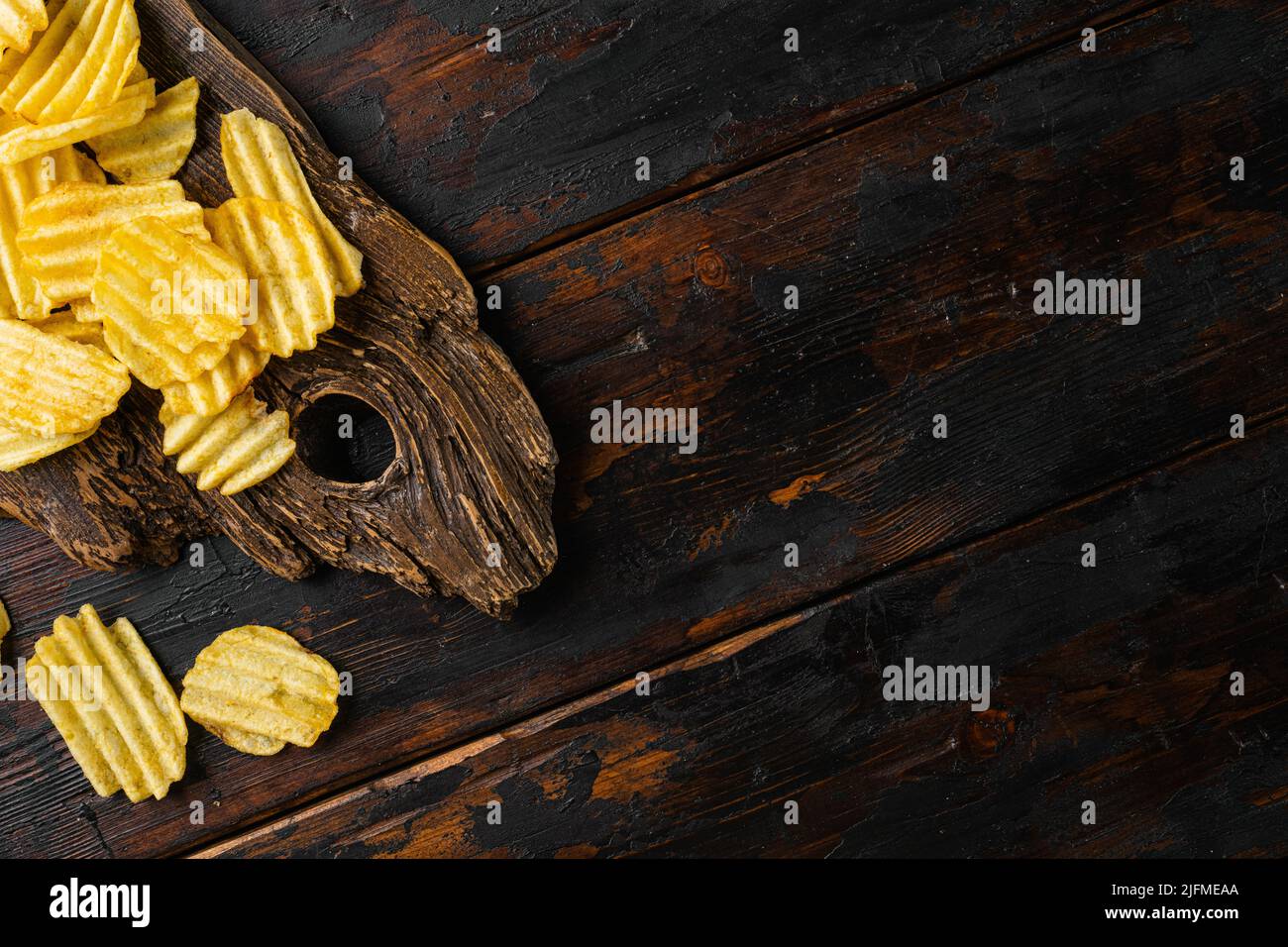 Wavy Ranch Flavored Potato Chips on old dark wooden table background ...