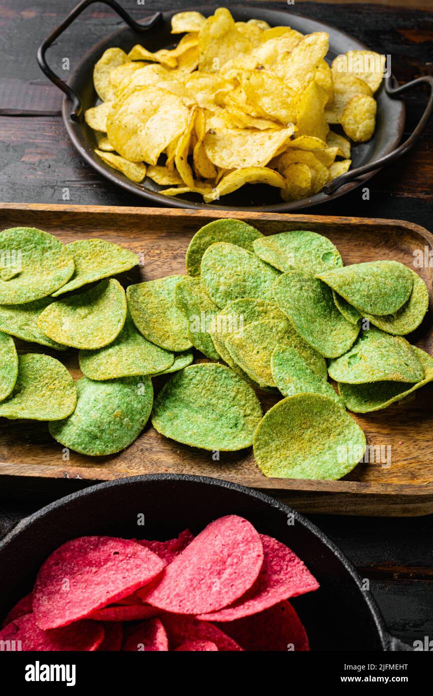 Green potato chips on old dark wooden table background Stock Photo - Alamy