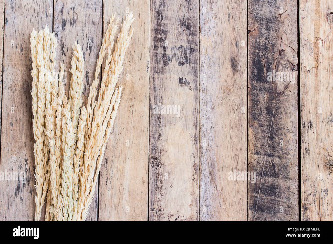 Ears of wheat on a brown wooden table background Stock Photo - Alamy
