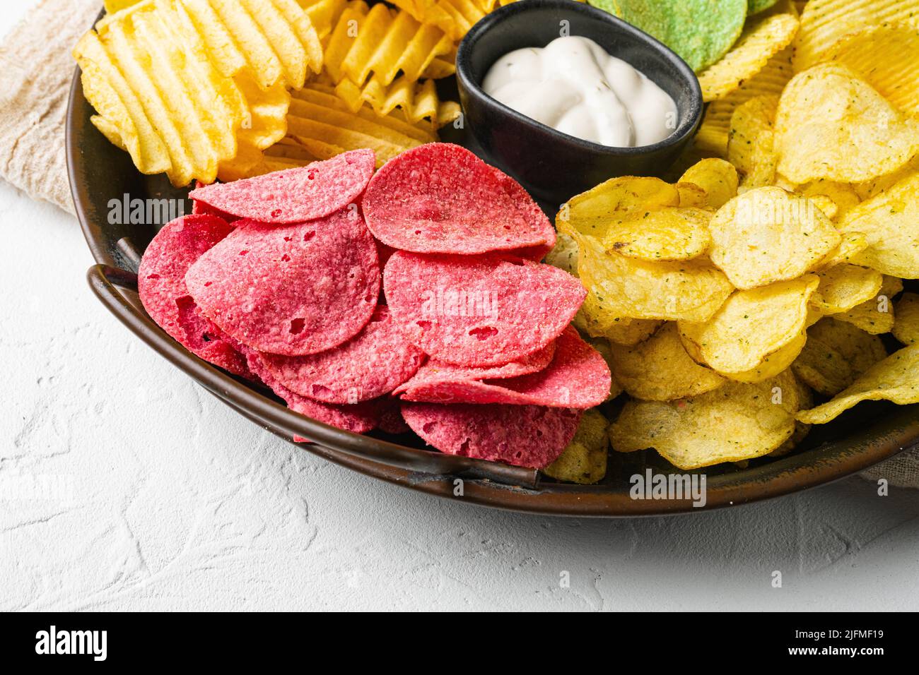 Variation different potato chips on white stone table background Stock ...