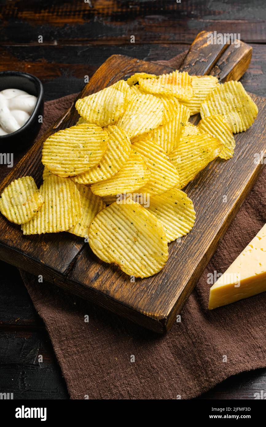 Wavy Ranch Flavored Potato Chips on old dark wooden table background ...