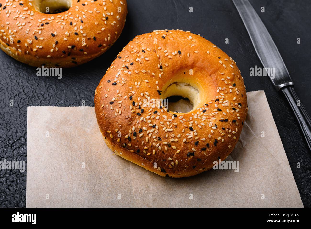 Bagel Freshly Baked set, on black dark stone table background Stock ...
