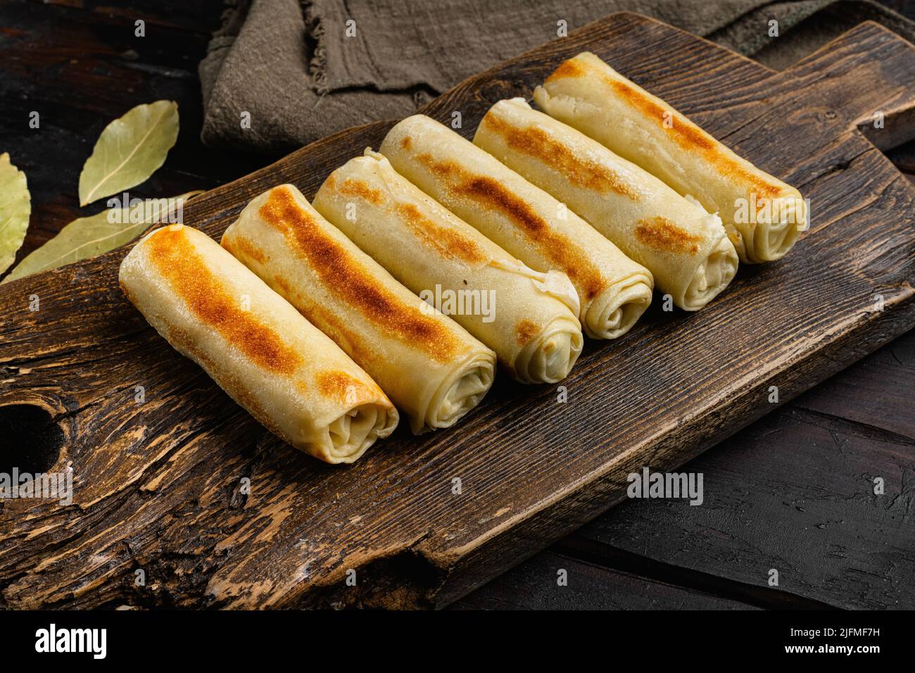 Georgian crepes stuffed on old dark wooden table background Stock Photo ...