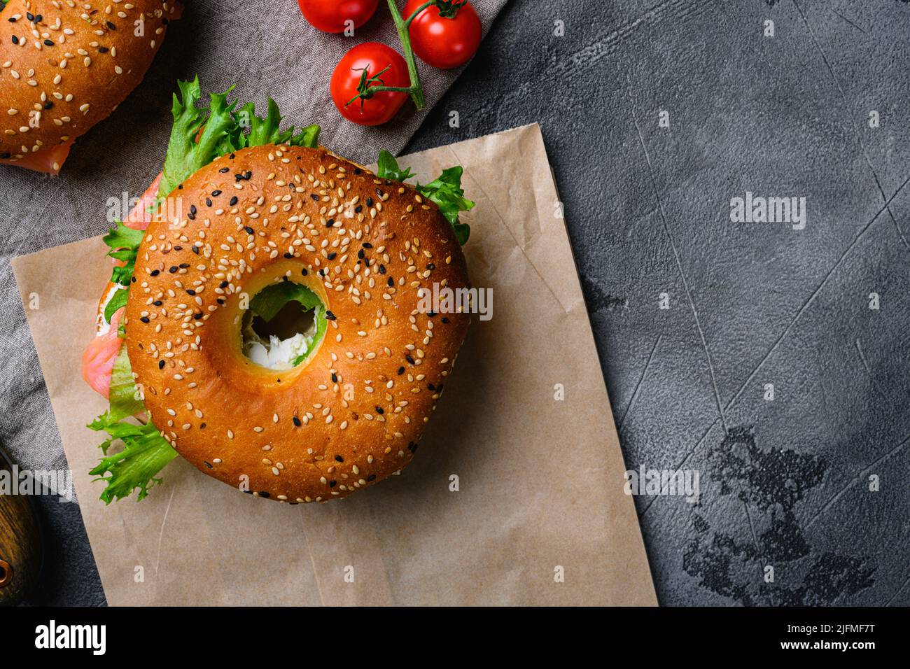 Bagel with red fish and soft cheese, on gray stone table background ...