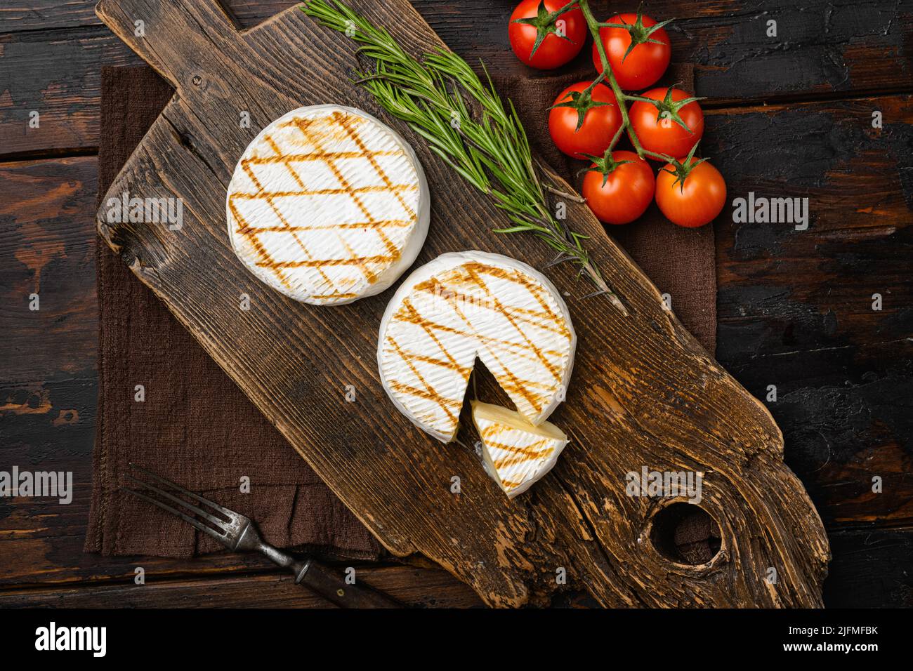 Oven Backed camembert on old dark wooden table background, top view ...