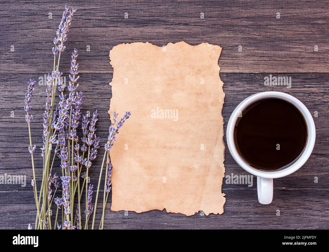 Old paper and coffee with lavender flower on dark wooden table ...